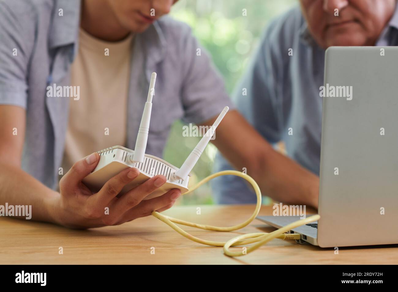 Young man installing wi-fi router in home of his father Stock Photo - Alamy