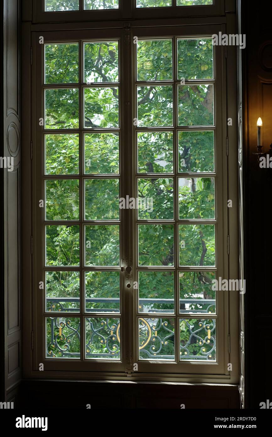A multi-pane French Window with shutters and a decorative ironwork ...