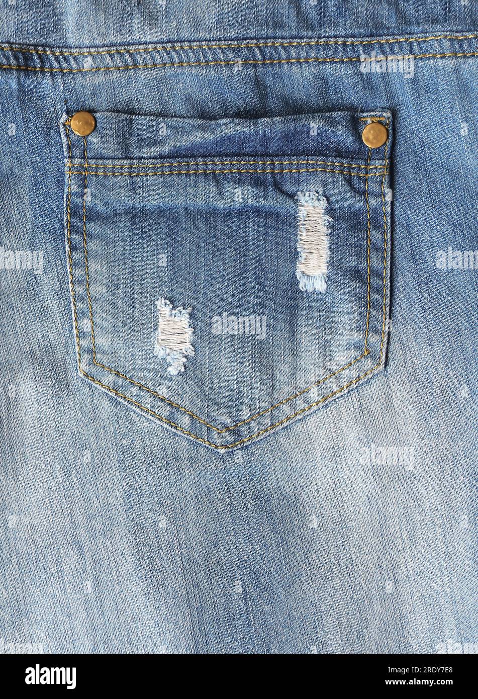 Ripped jeans pocket of indigo color. Vertical background with denim ...