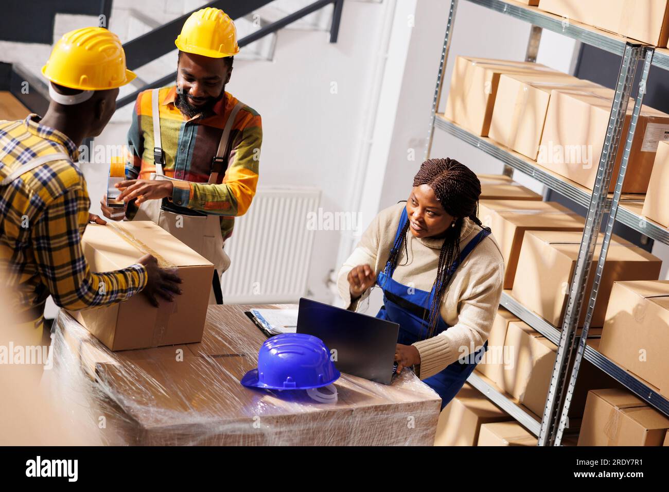 Warehouse manager checking orders list and coordinating parcels packing ...