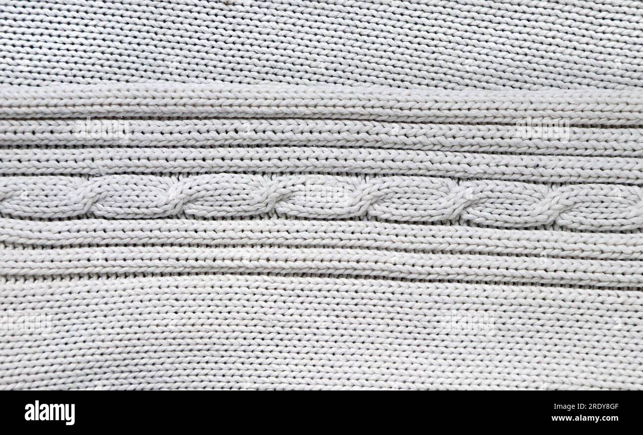 Wool sweater texture of white color with cable knitting stitch pattern ...