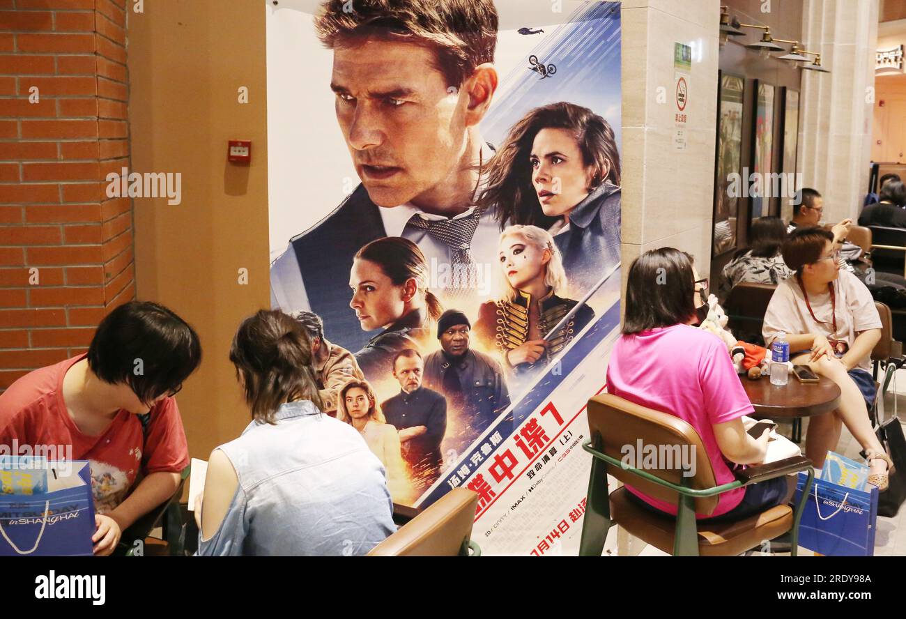 SHANGHAI, CHINA - JULY 14, 2023 - Fans pass a poster of "Mission ...