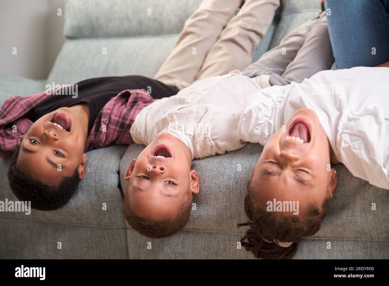 Happy children bonding and enjoying childhood together upside down on ...