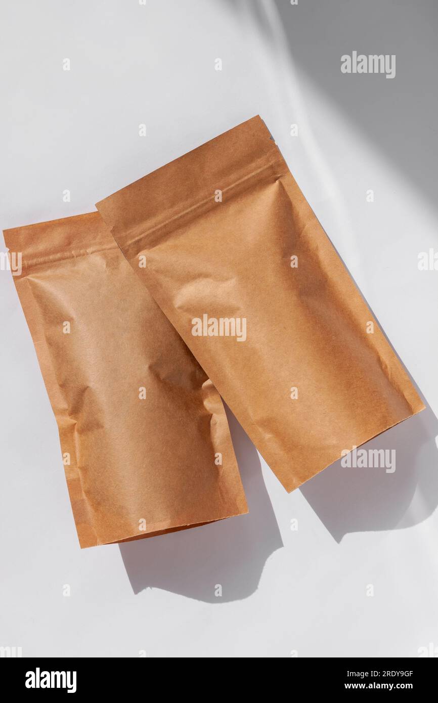 Brown kraft paper pouch bags with coffee beans top view with shadow ...