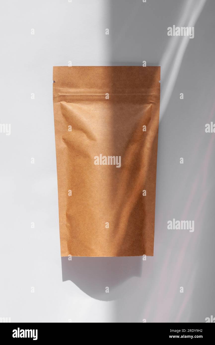 Brown kraft paper pouch bags with coffee beans top view with shadow ...