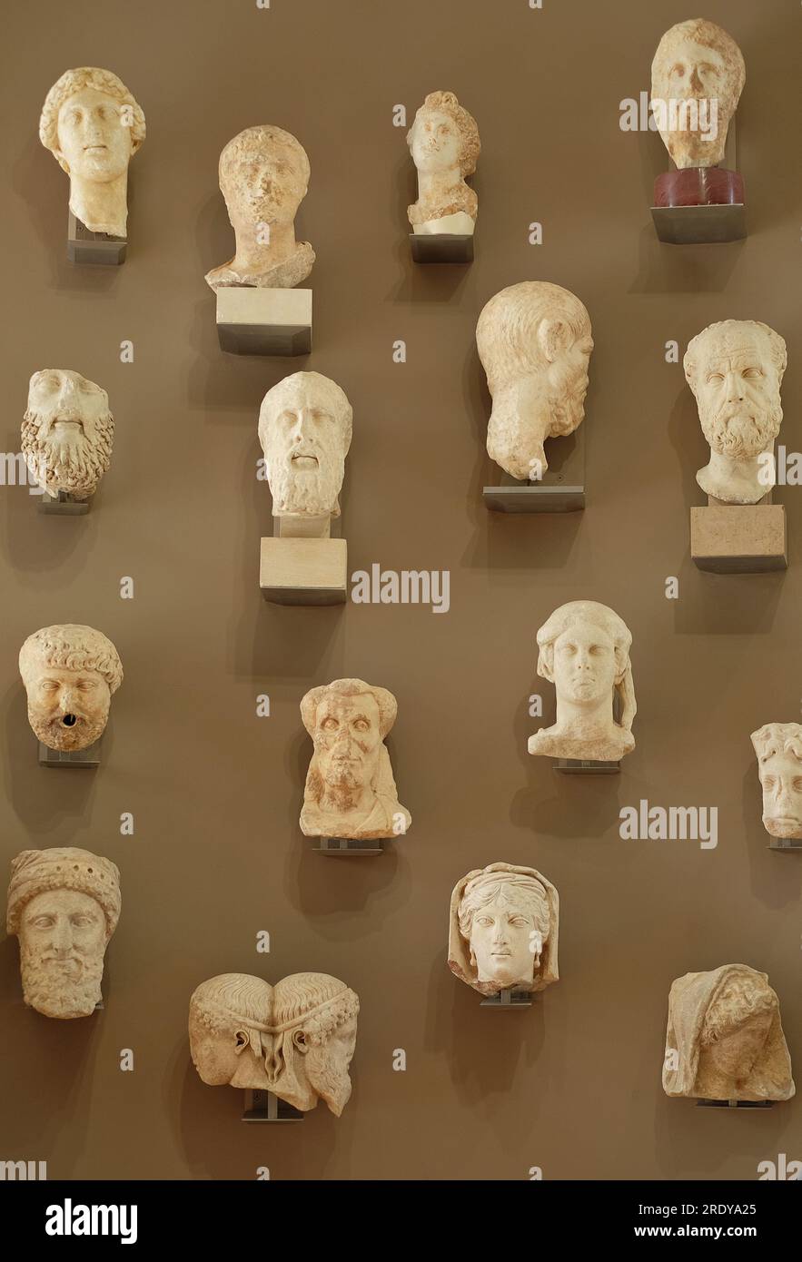 A collection of Busts of Heads mounted on a wall in Musée Rodin, Greek ...