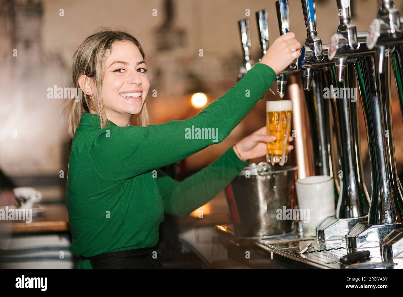 Young employee filling glass beer hi-res stock photography and images ...