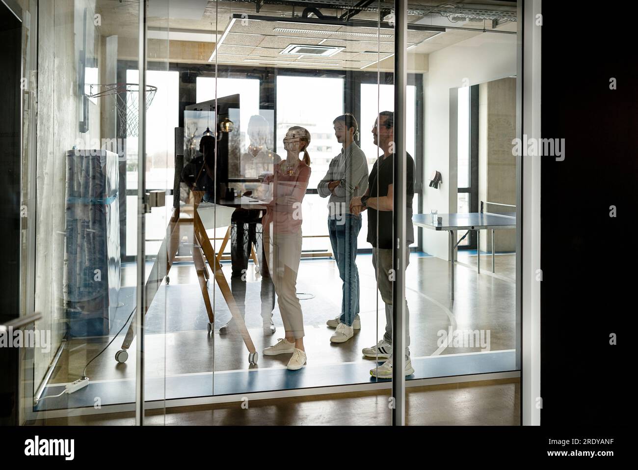 Businessmen and businesswoman having discussion over interactive ...