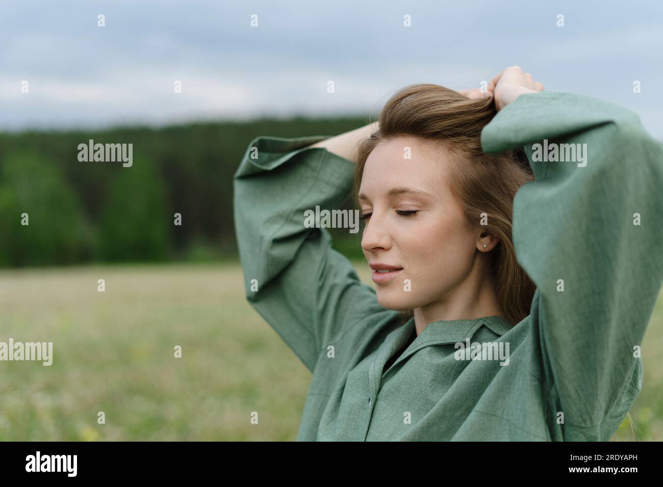 Woman tying hair summer hi-res stock photography and images - Alamy