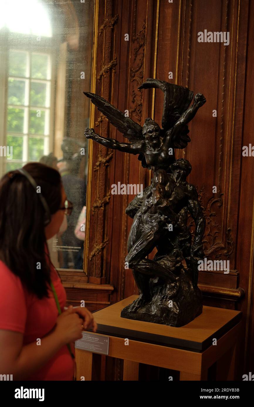 A woman looking at the bronze La Defense, also known as The Call to ...