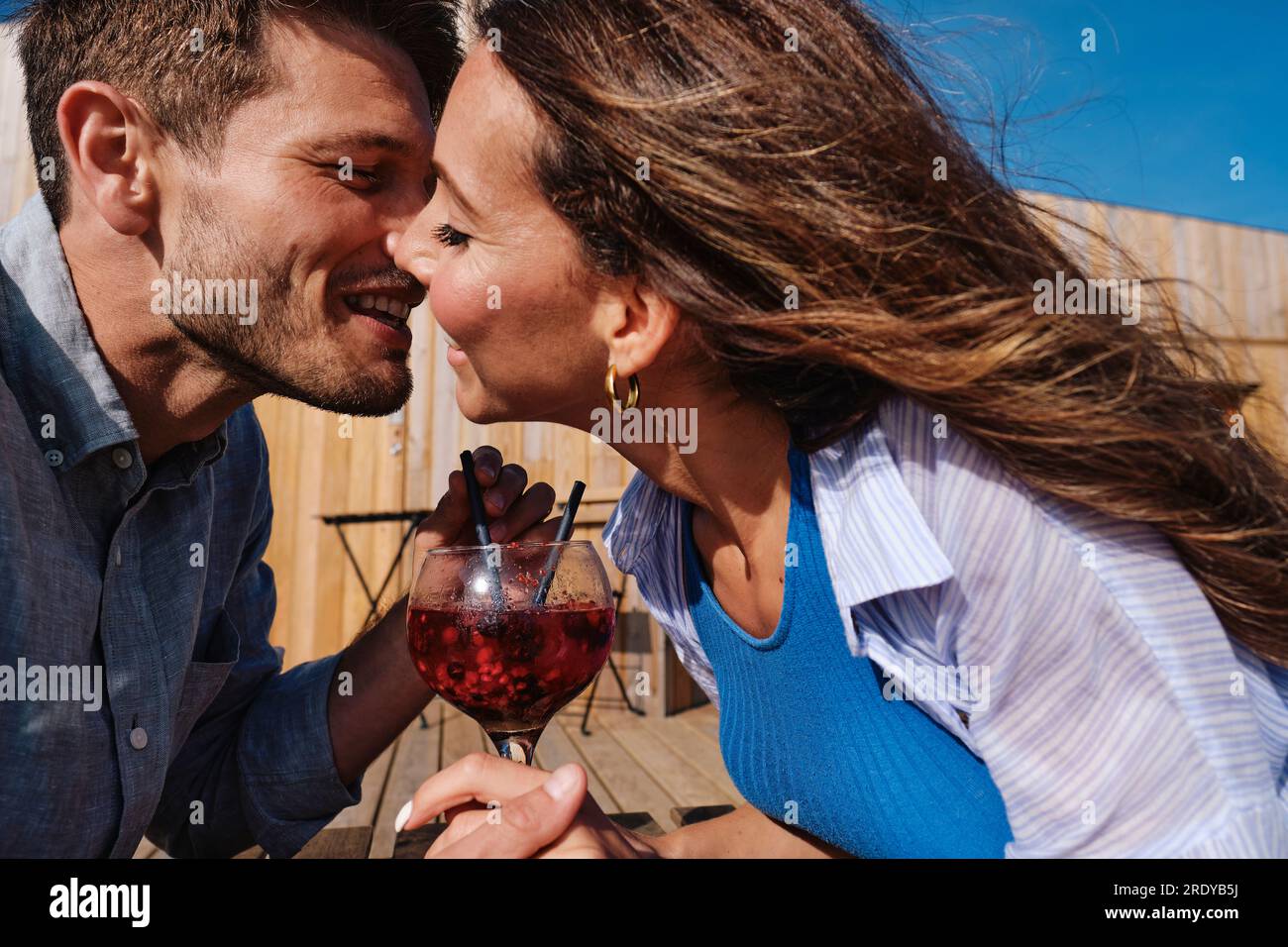 Romantic couple kissing on table at beach Stock Photo - Alamy
