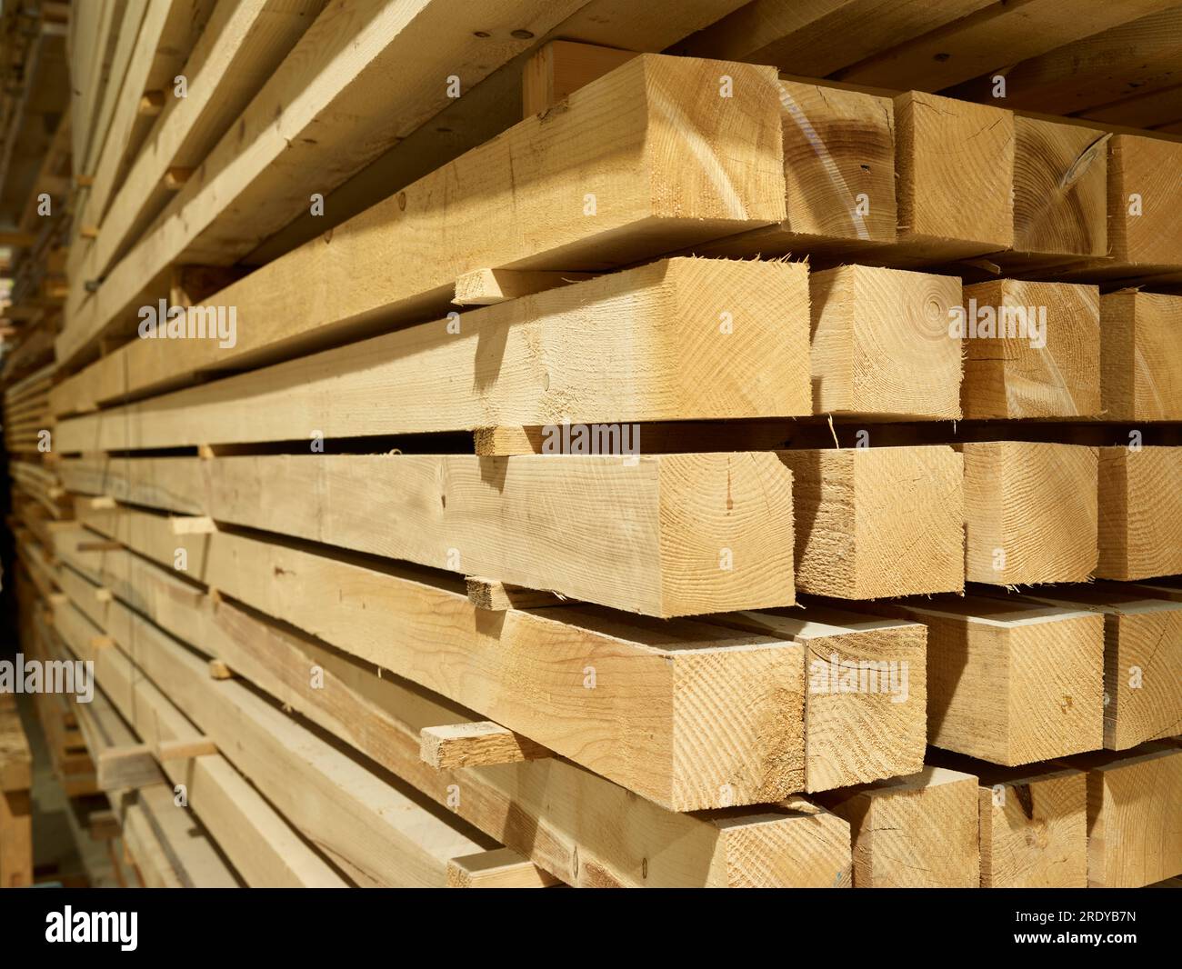 Stacked square shaped timbers in workshop Stock Photo - Alamy