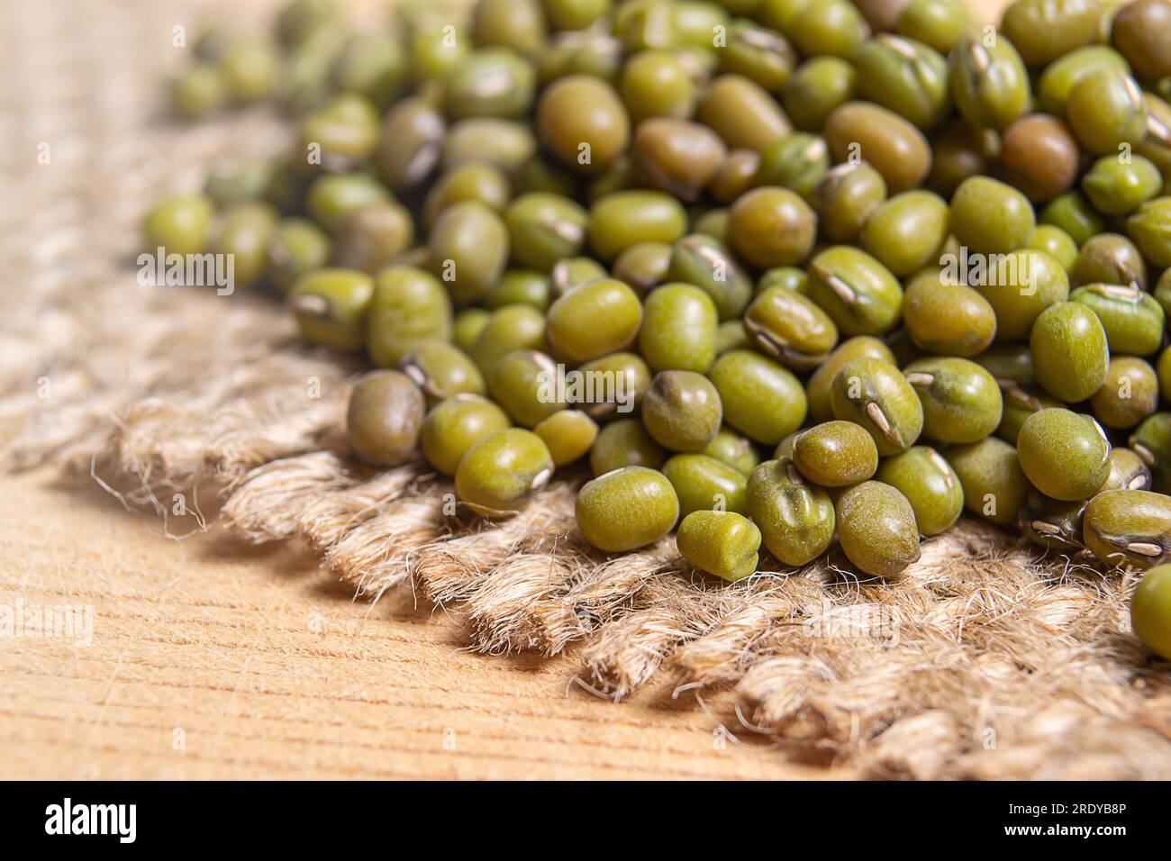 Mung beans on top of a jute fabric on wood surface Stock Photo - Alamy