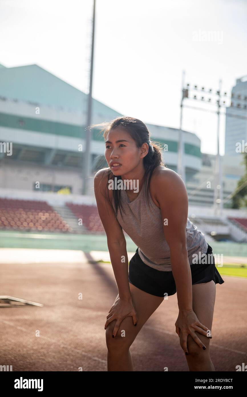 Tired female athlete stretching hi-res stock photography and images - Alamy