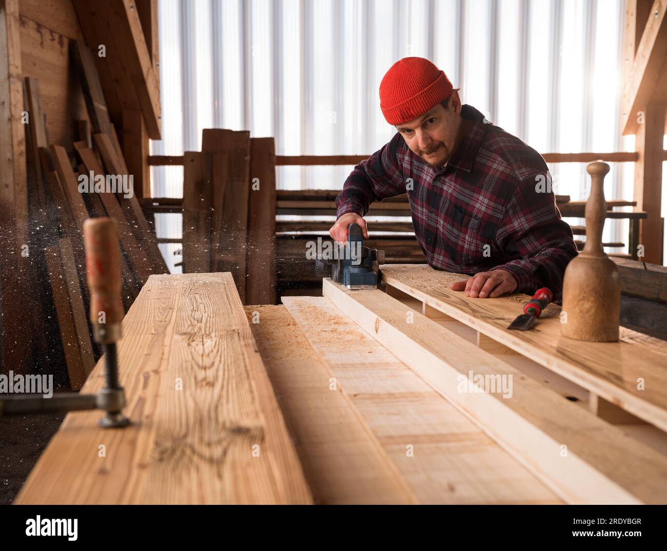 Carpenter working with hand planner at workshop Stock Photo - Alamy