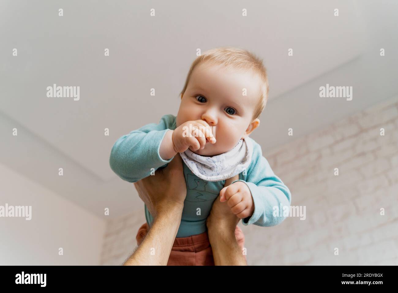 Father lifting cute baby boy Stock Photo - Alamy