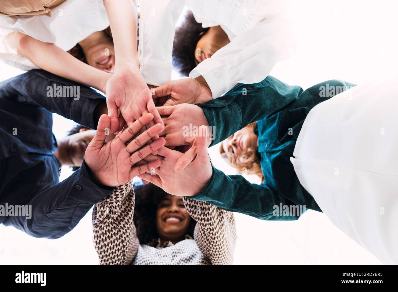 Happy businesswomen stacking hands and huddling together in unity Stock ...