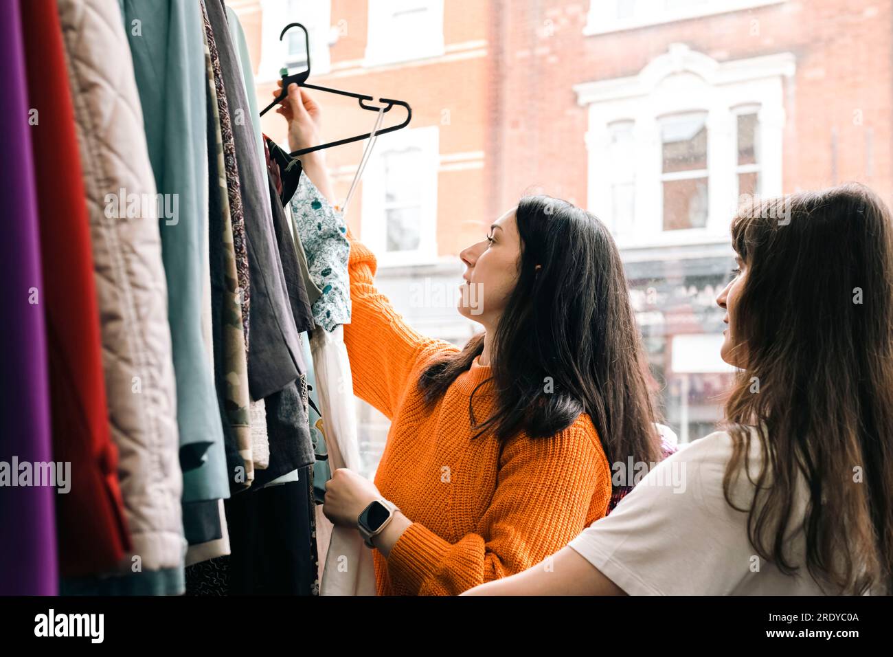 Two friends shopping clothes in hi-res stock photography and images - Alamy