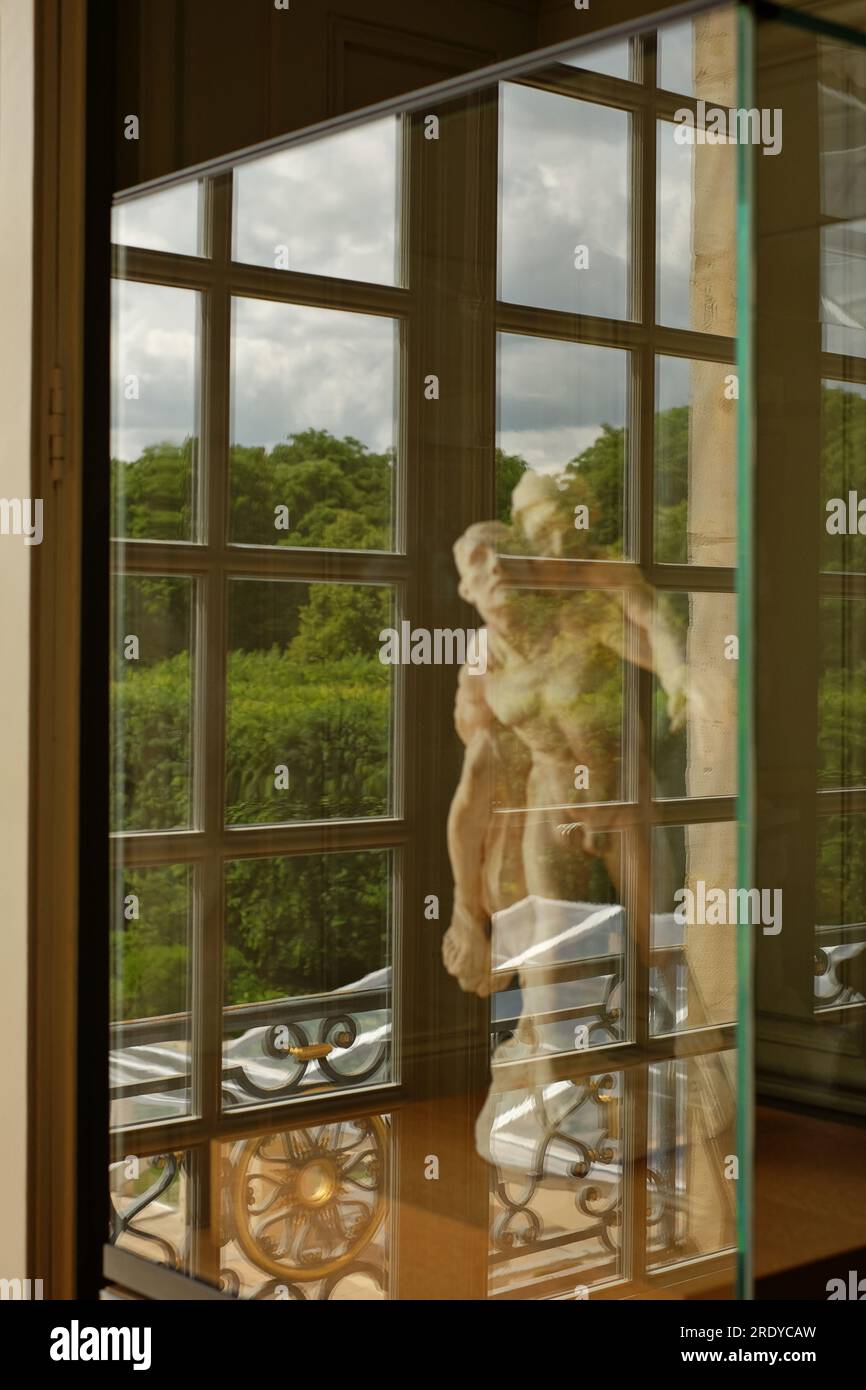 A decorative window view of the Hôtel Biron garden, with a ghost image ...