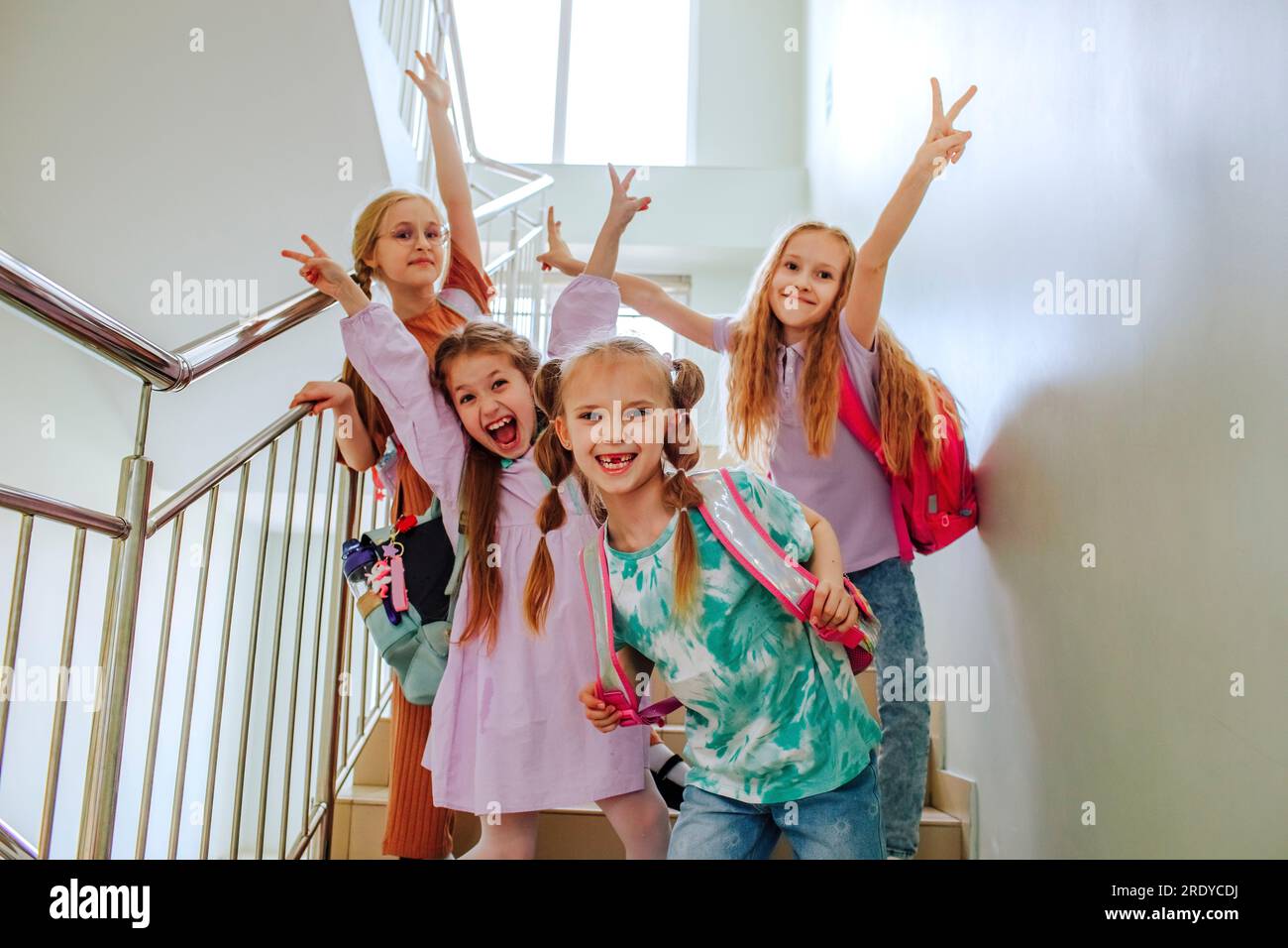 Smiling girl raising hand hi-res stock photography and images - Alamy