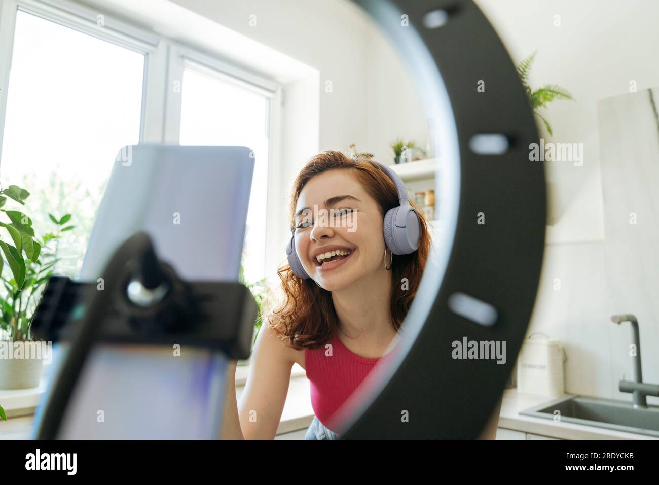 Happy influencer filming with smart phone at home Stock Photo - Alamy