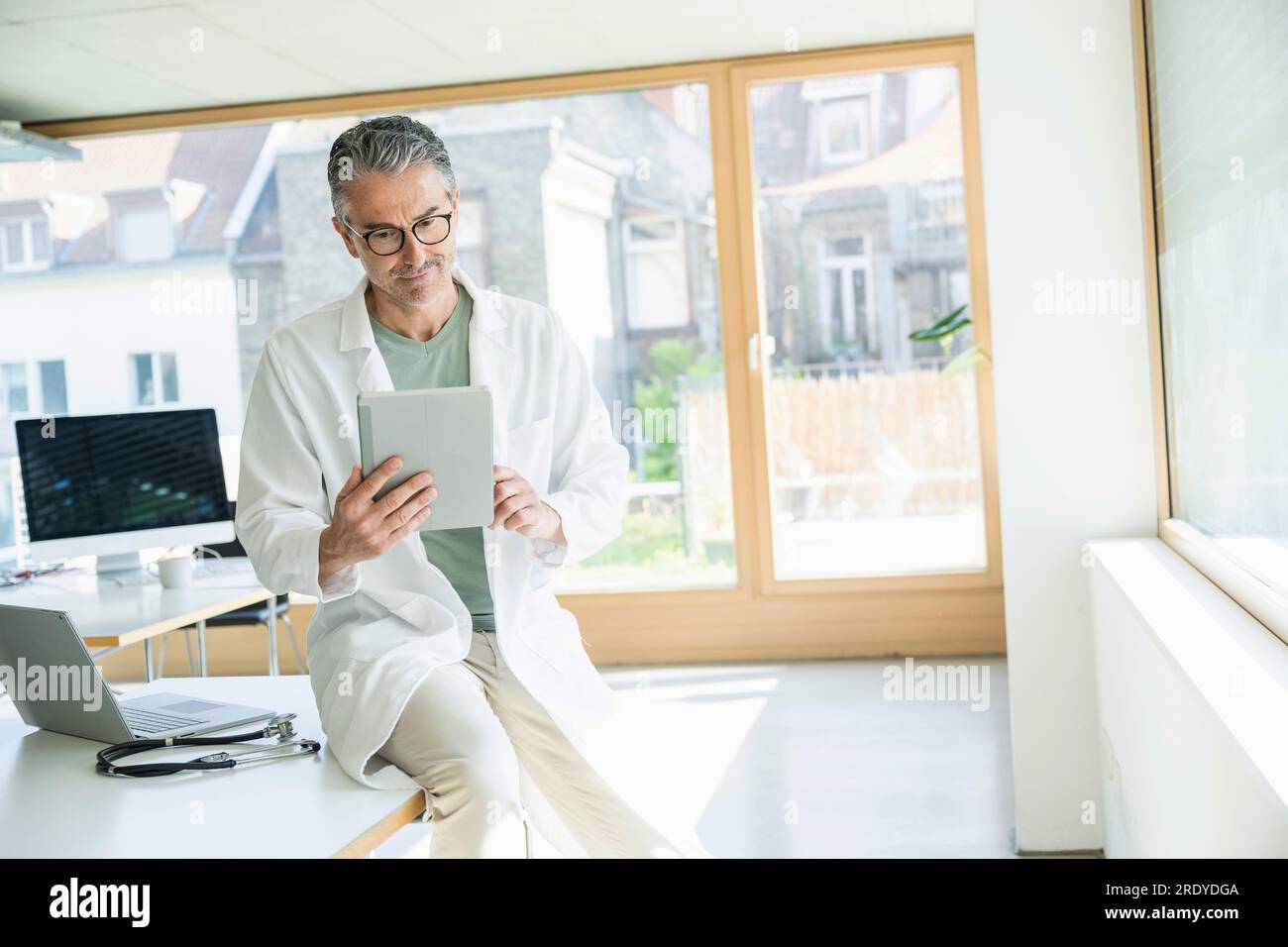 Doctor sitting workplace in office hi-res stock photography and images ...