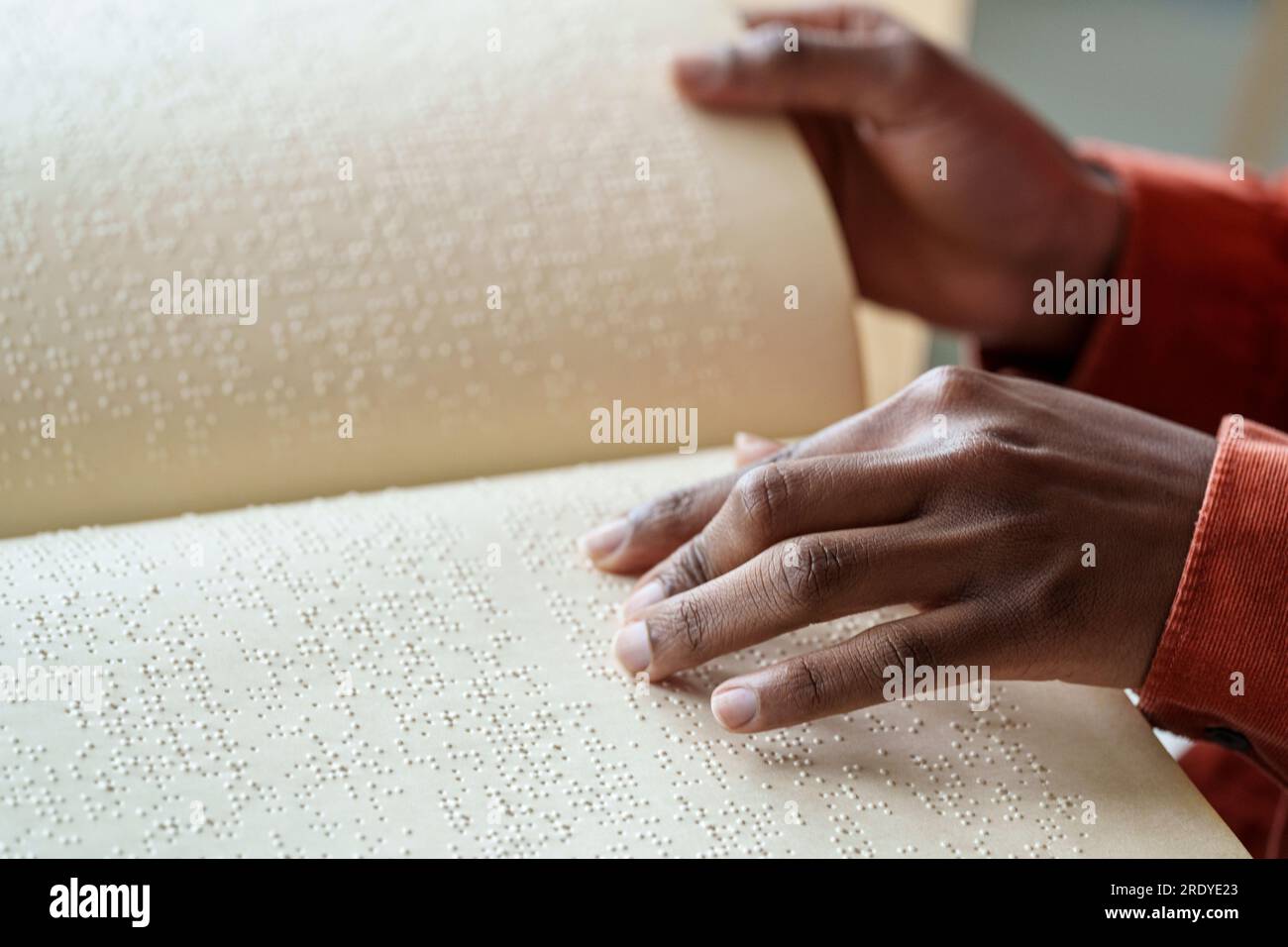 Hand of woman reading text from braille Stock Photo - Alamy