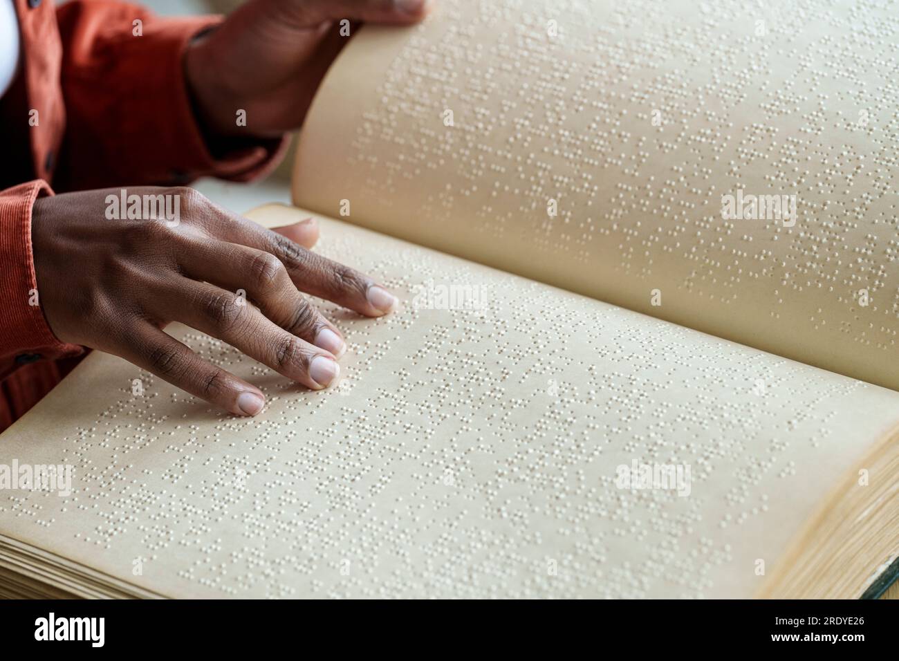 Hands of woman reading braille text Stock Photo - Alamy