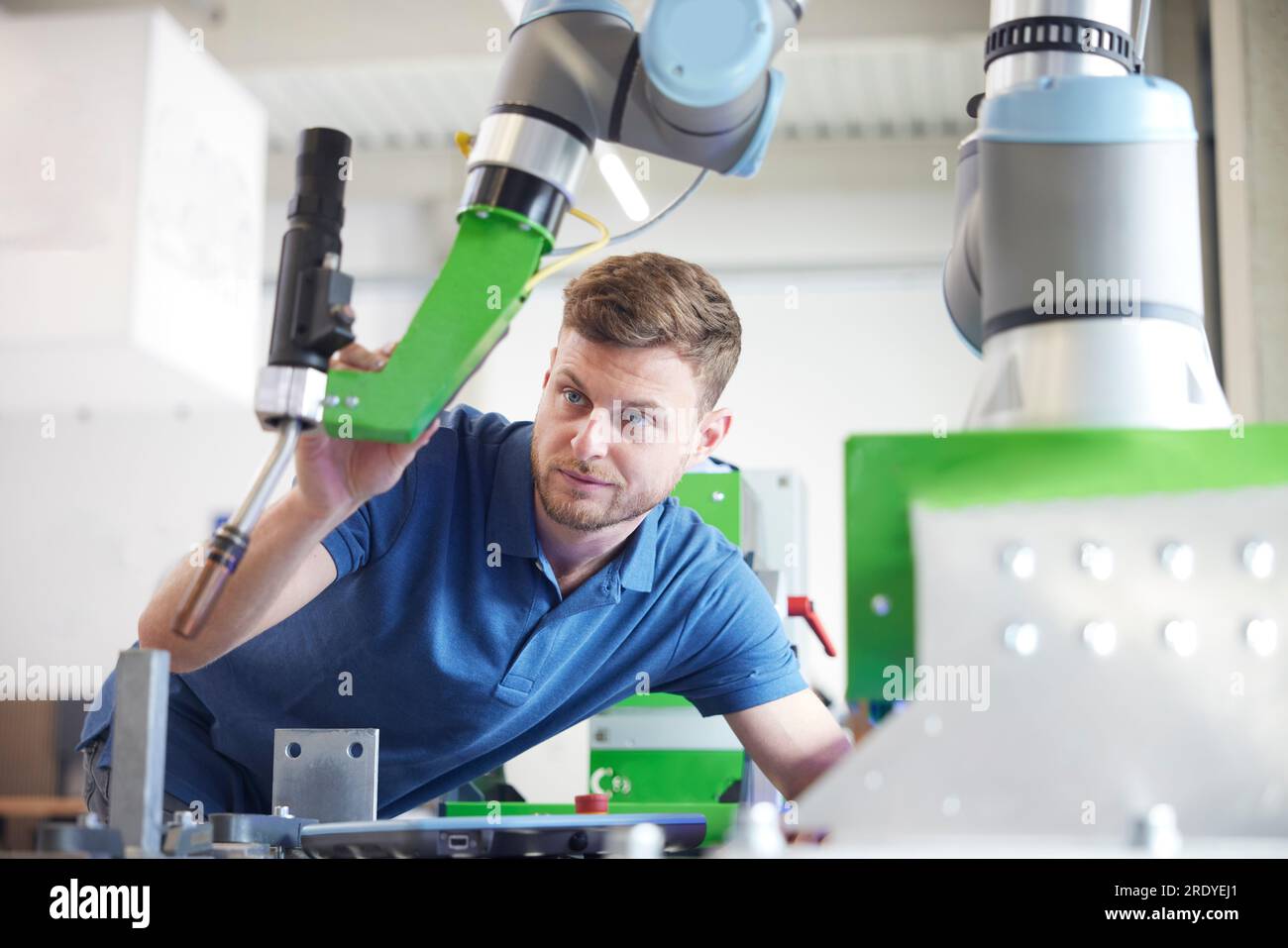 Technician testing machine part in modern factory Stock Photo - Alamy