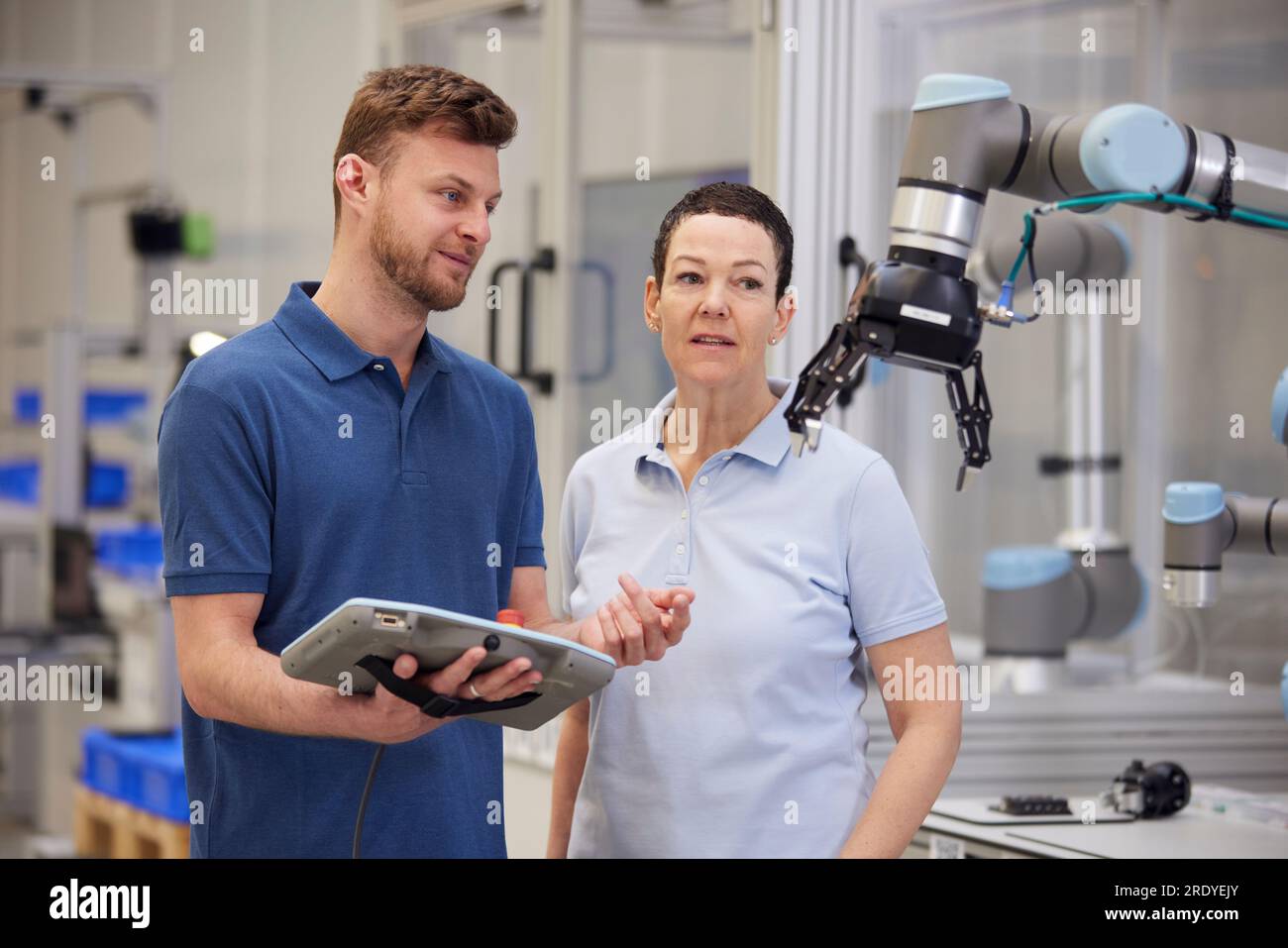 Engineers discussing together standing in modern factory Stock Photo ...