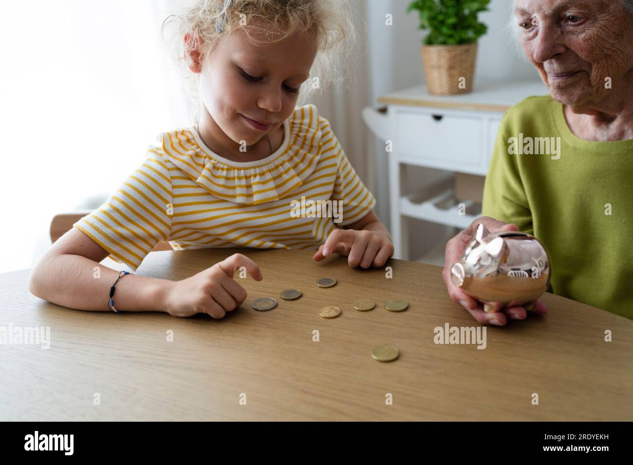 Grandmother grandchild piggy bank hi-res stock photography and images ...