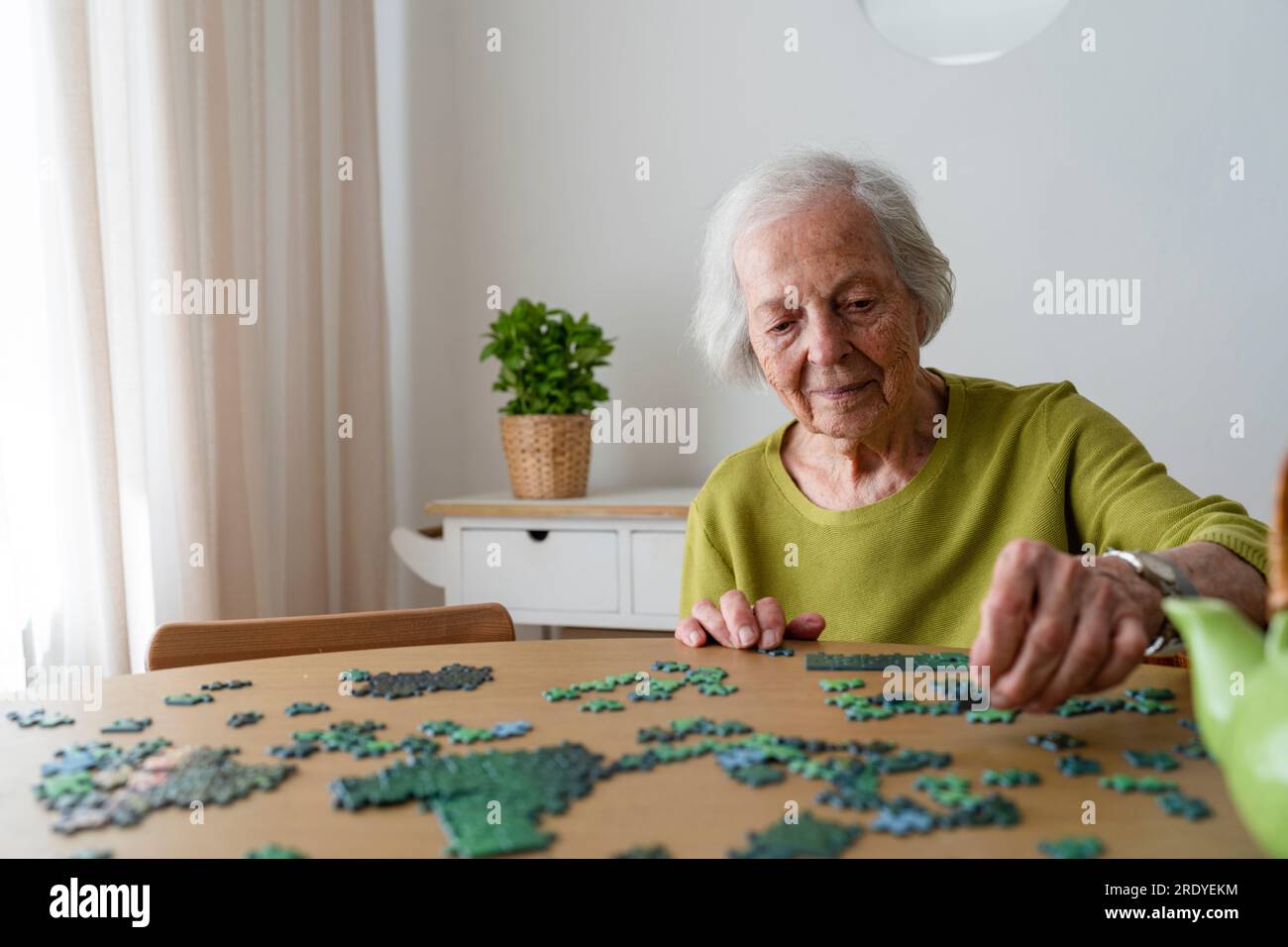 Person doing jigsaw puzzle hi-res stock photography and images - Alamy