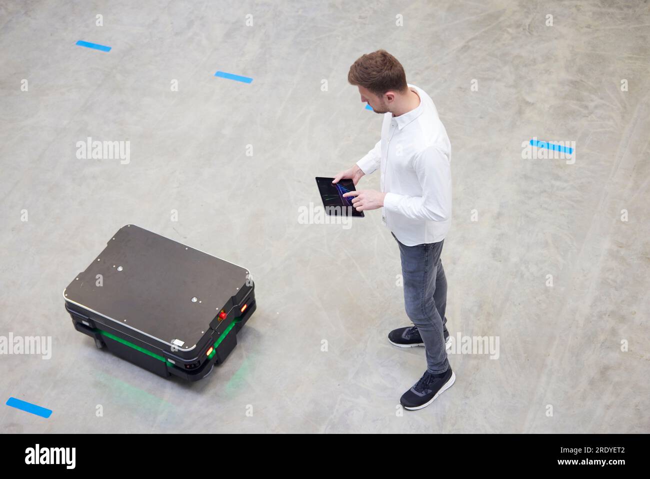 Engineer testing mobile robot through tablet PC in industry Stock Photo ...