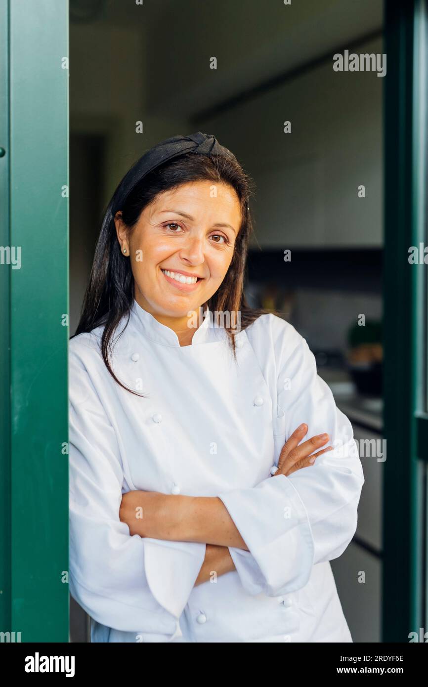 Happy female chef arms crossed hi-res stock photography and images - Alamy