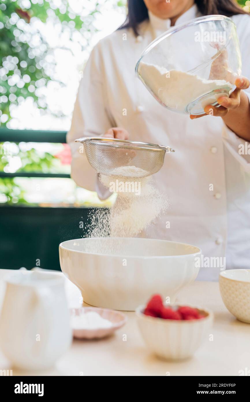 Woman sieving flour in hi-res stock photography and images - Alamy