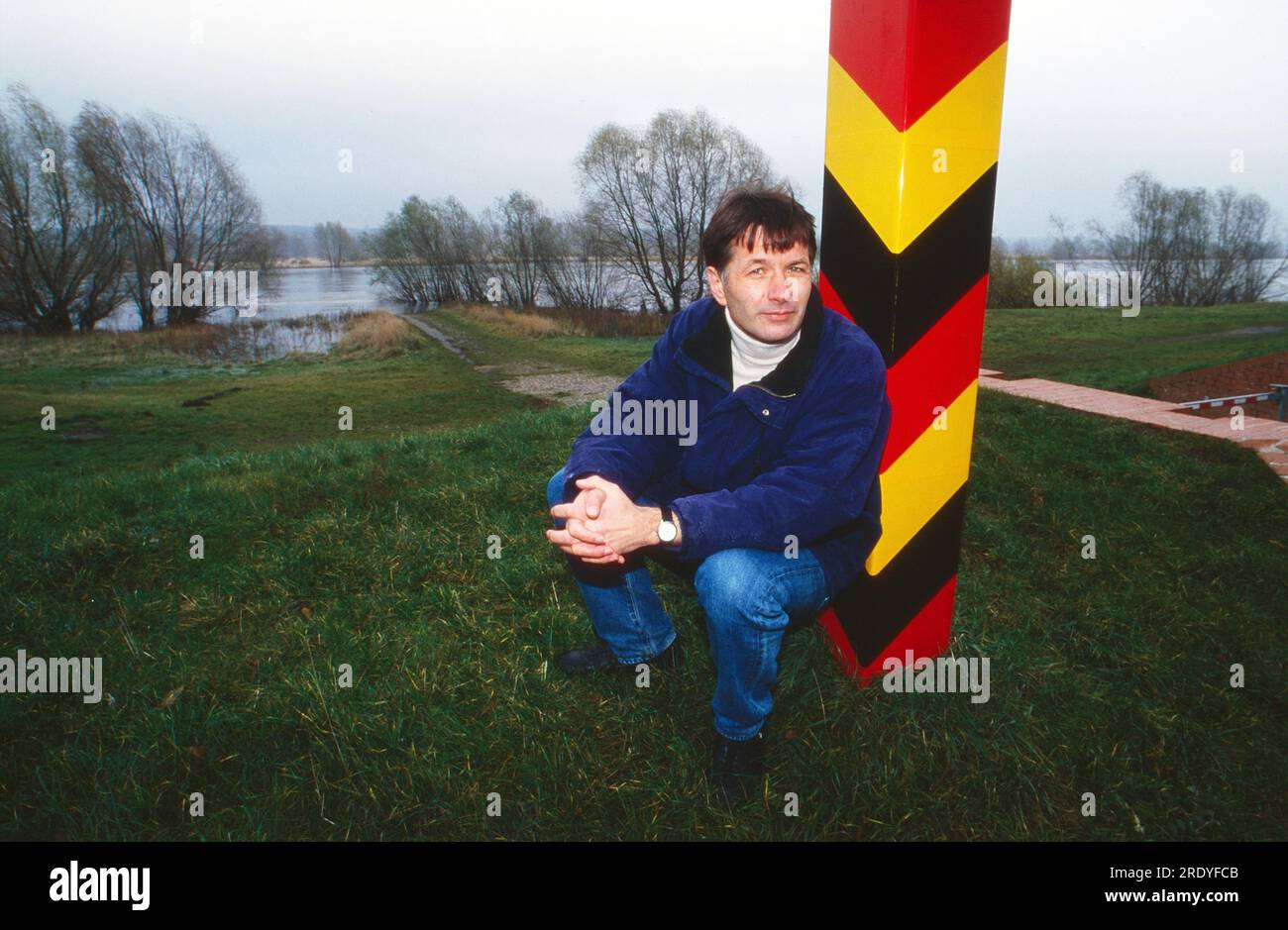 Thomas Rühmann, deutscher Schauspieler und Musiker, an einem Grenzpfahl ...