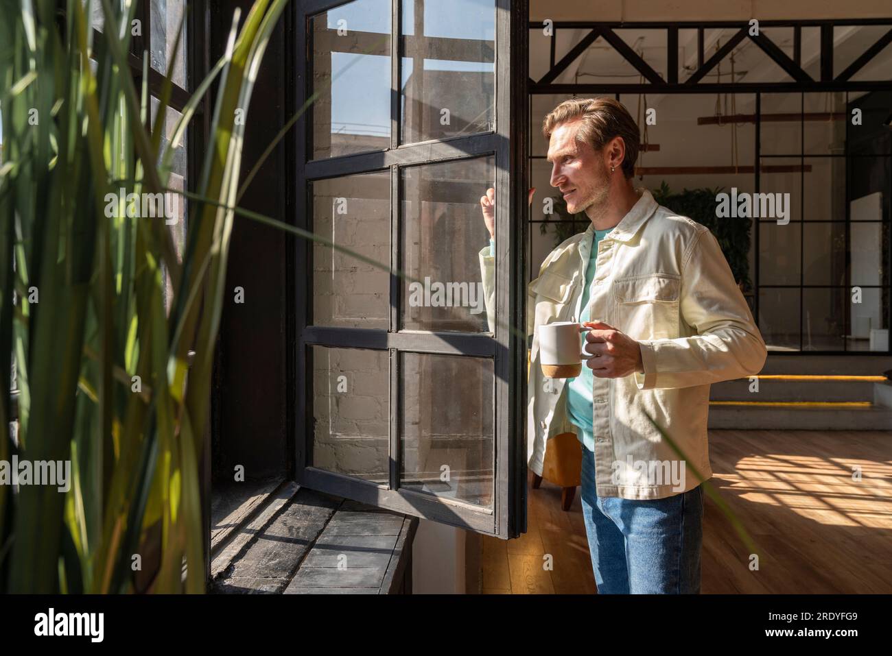 Man looking window home hi-res stock photography and images - Alamy