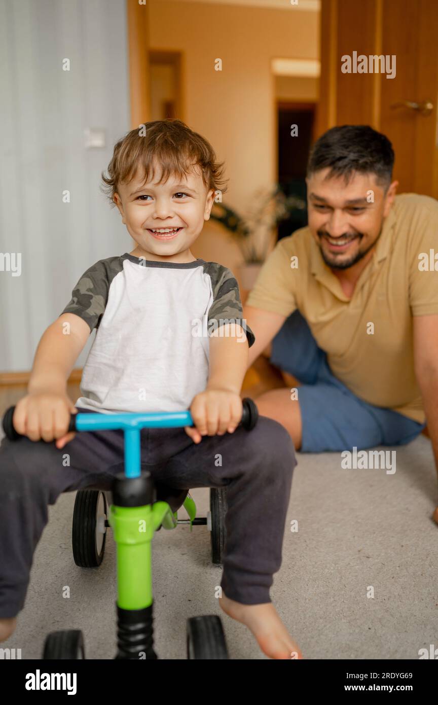 Child playing cycle hi-res stock photography and images - Alamy