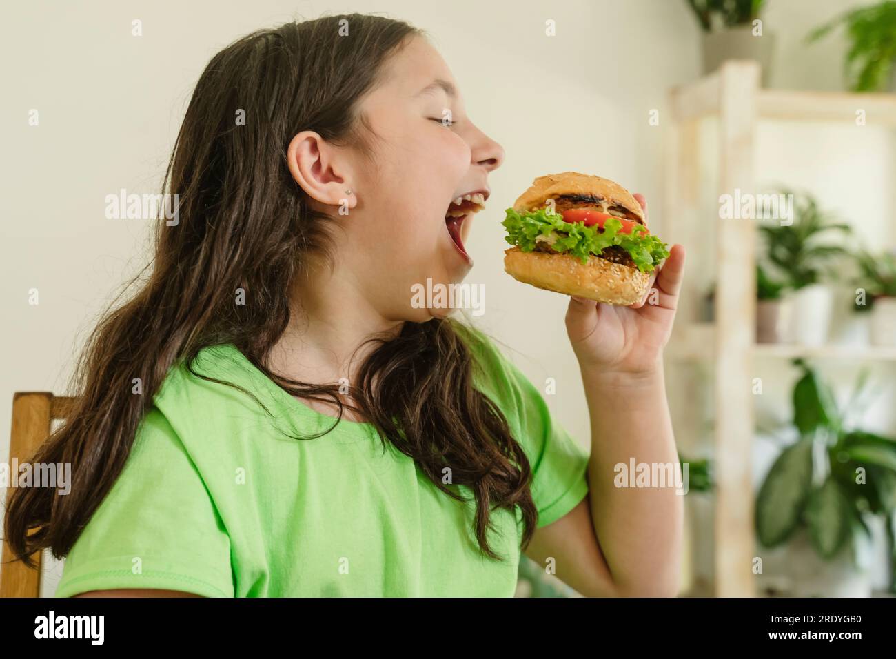 Child eating hamburger on hi-res stock photography and images - Alamy