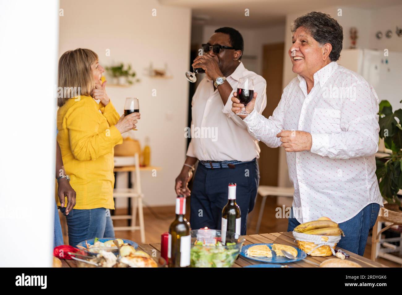 Happy man having fun with friends at dinner party in home Stock Photo ...