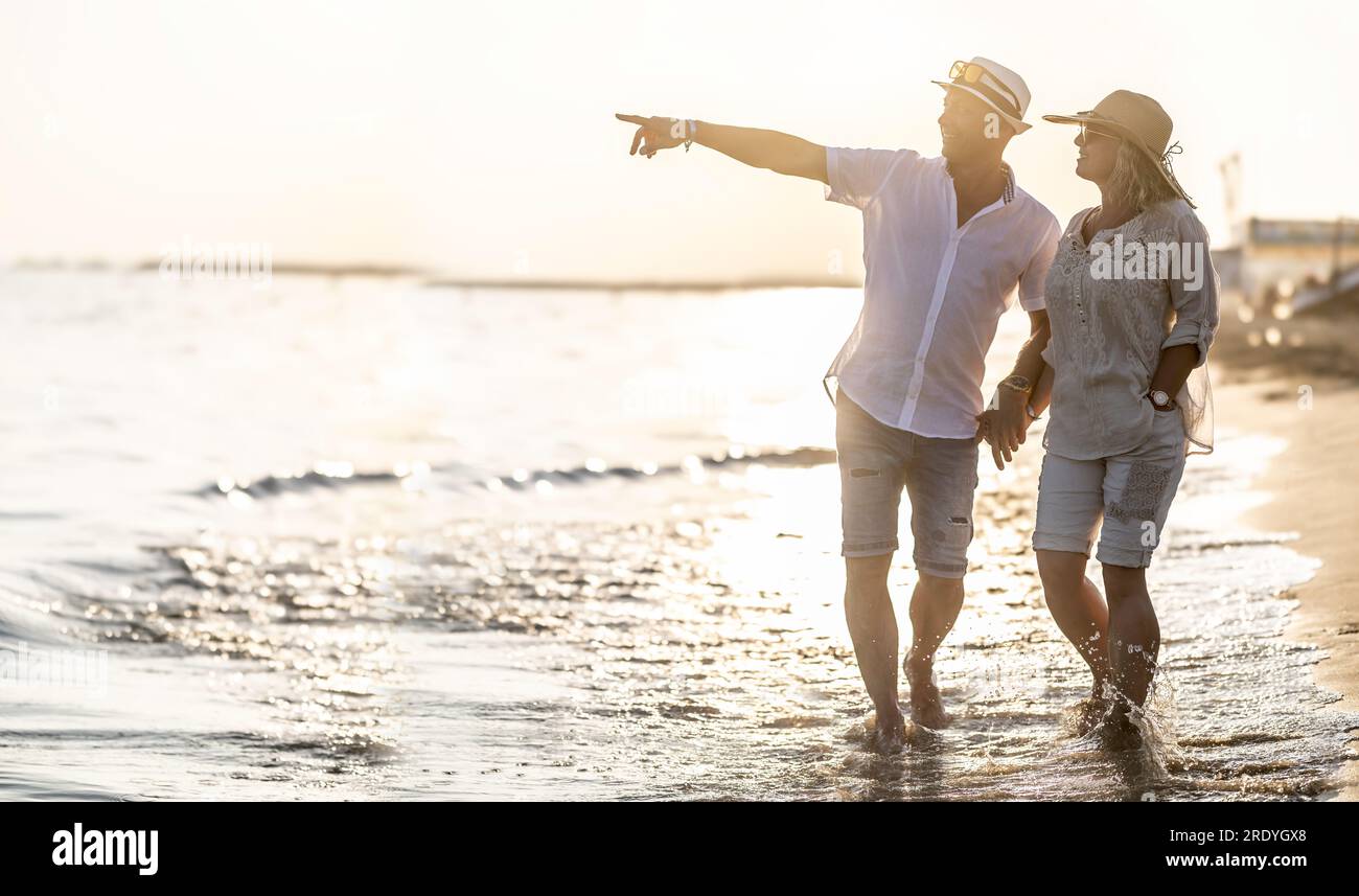 Romantic couple looking distance sunset hi-res stock photography and ...