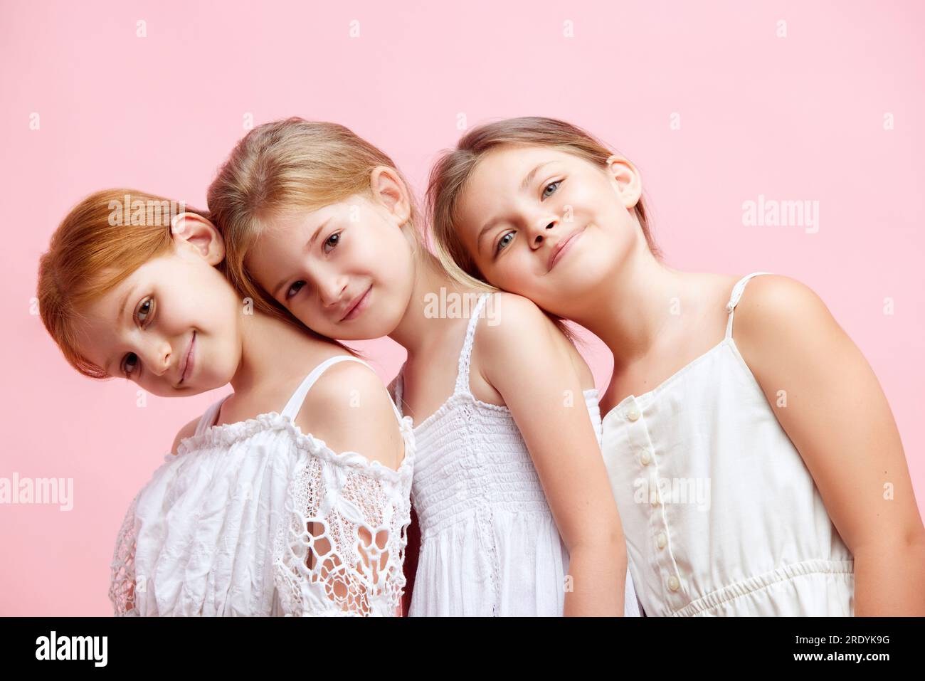 Portrait of beautiful little girls, children posing together against ...