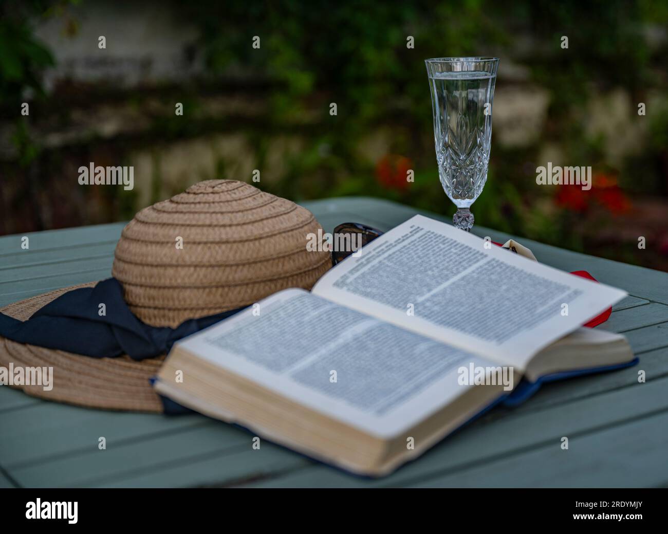 Summer iconic scene of a hot lazy summers day - a sun hat, book, a ...