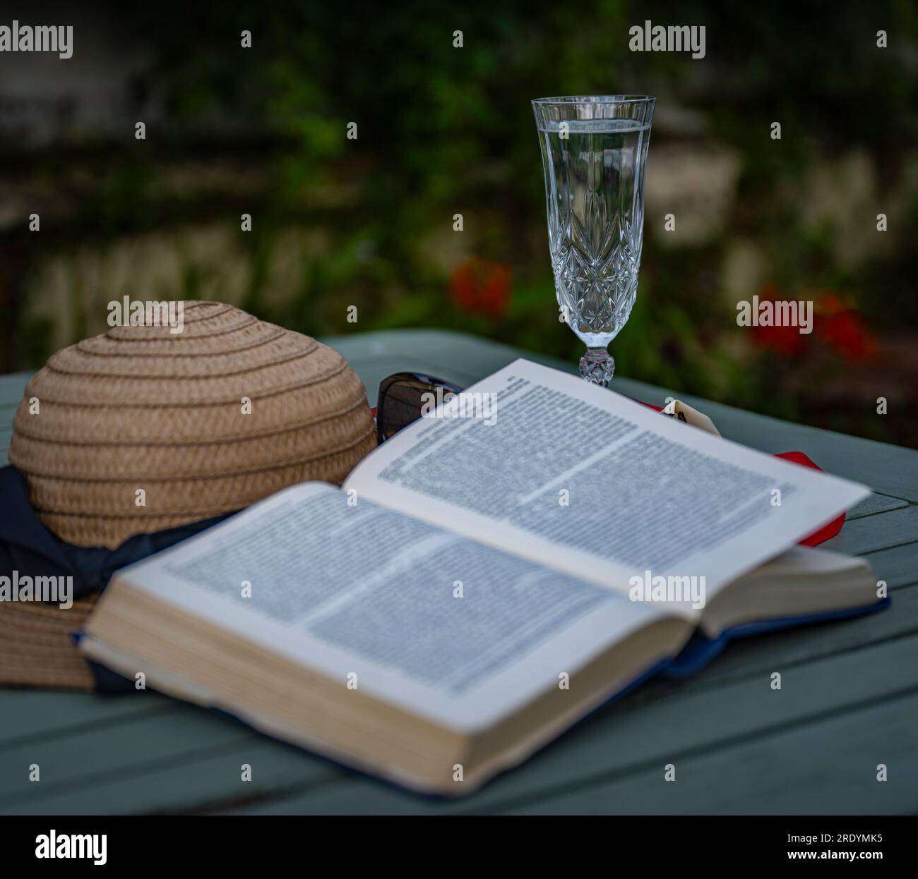 Summer iconic scene of a hot lazy summers day - a sun hat, book, a ...