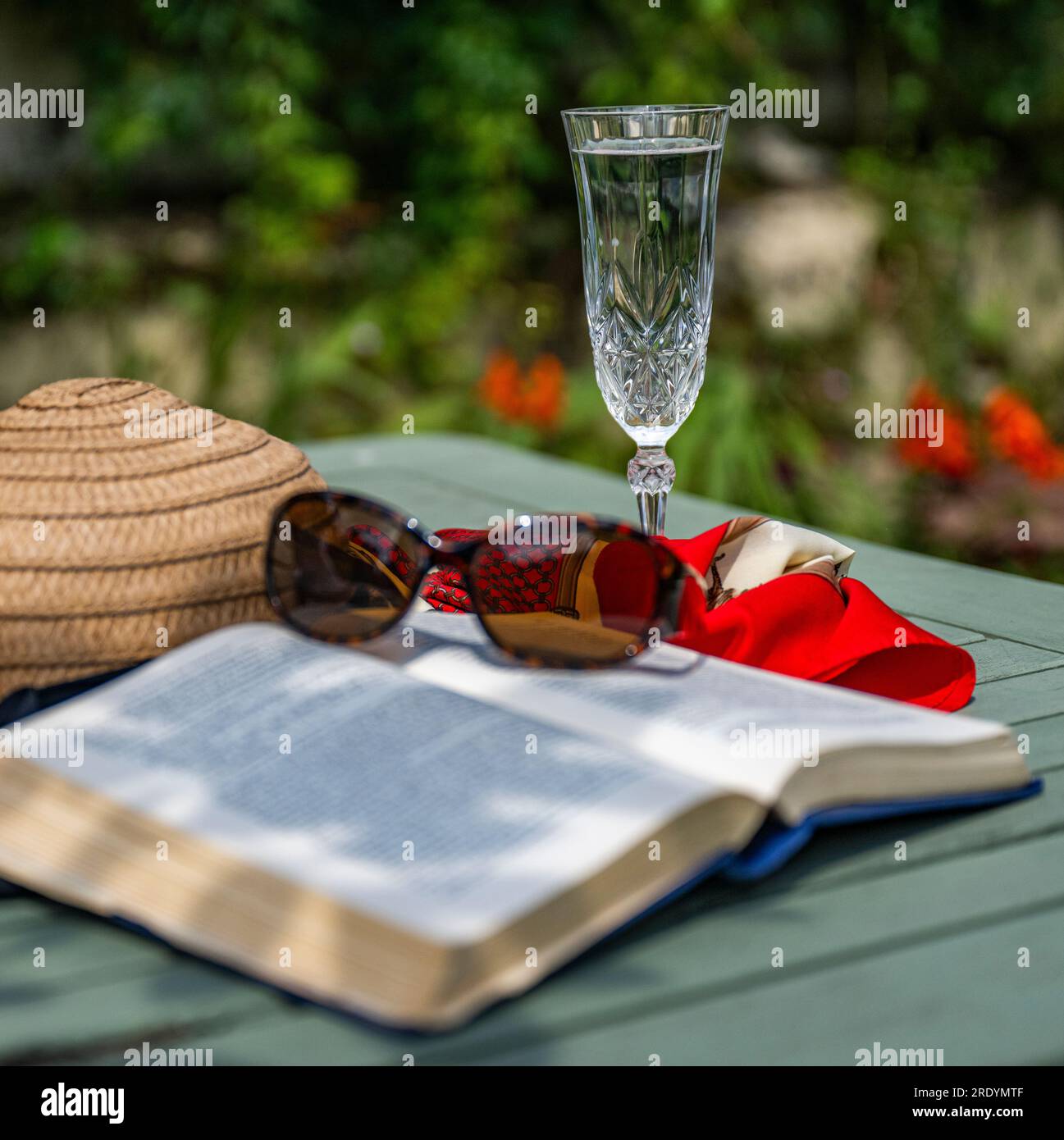 Summer iconic scene of a hot lazy summers day - a sun hat, book, a ...
