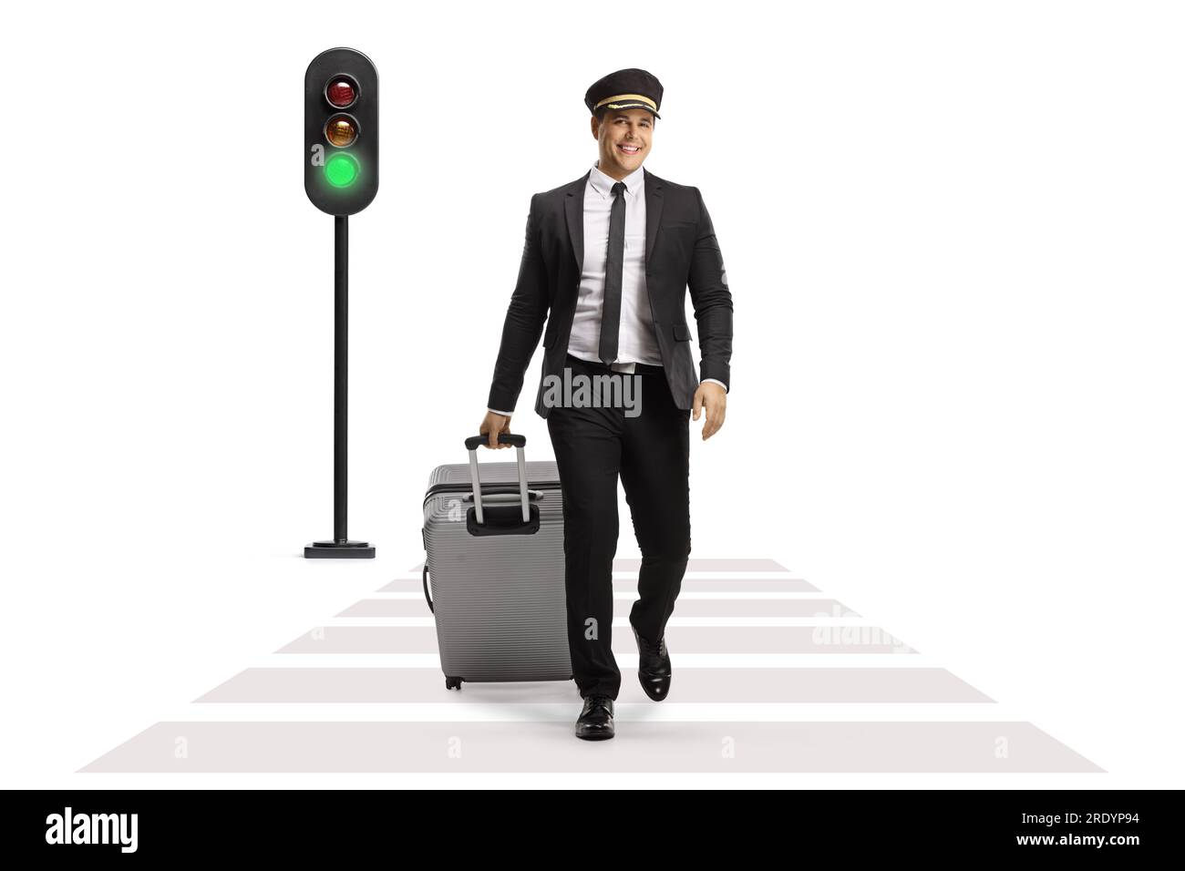 Pilot pulling a suitcase and crossing a street isolated on white ...