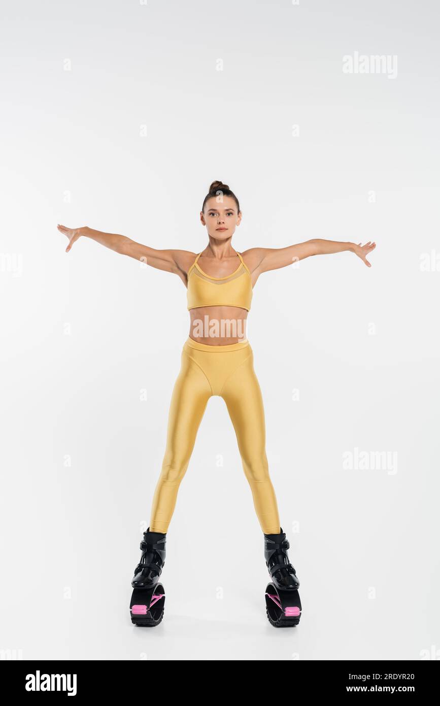 woman in fitness clothing wearing kangoo jumping shoes, white ...