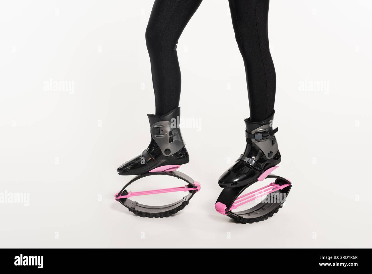 fun workout, partial view of woman in kangoo jumping shoes on white ...