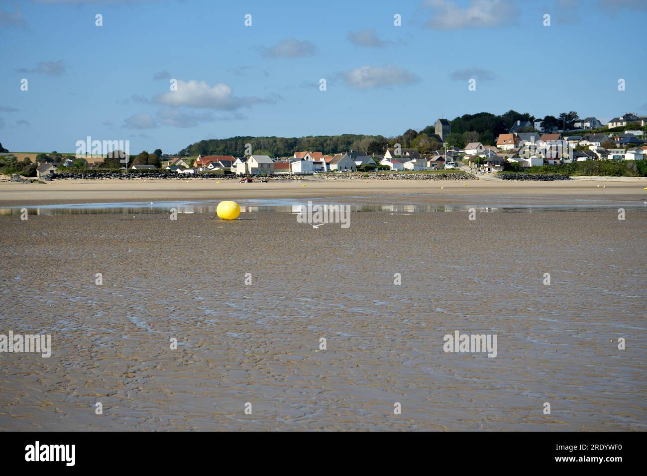 , July 6, 2023. Beach with buildings behind, and yellow marker buoy ...