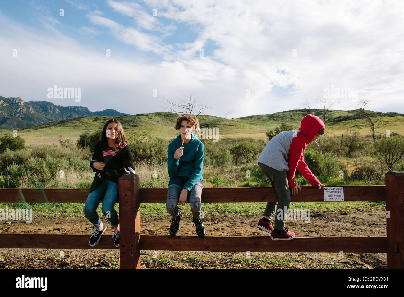 Teen girl sitting on fence hi-res stock photography and images - Alamy